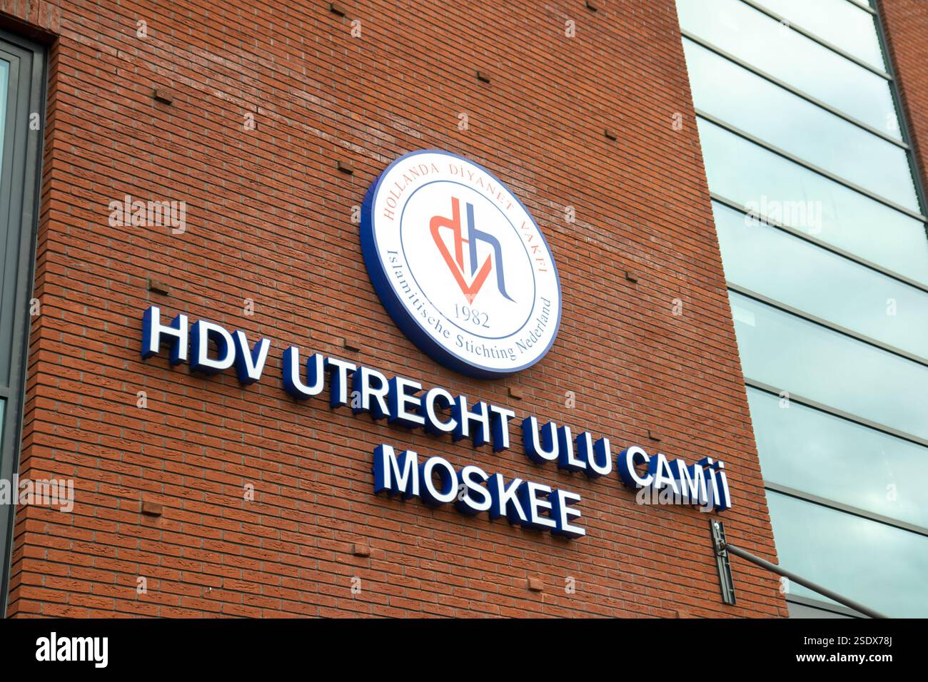 The Ulu mosque logo signage on the brick wall. Opened in 2014, it is ...