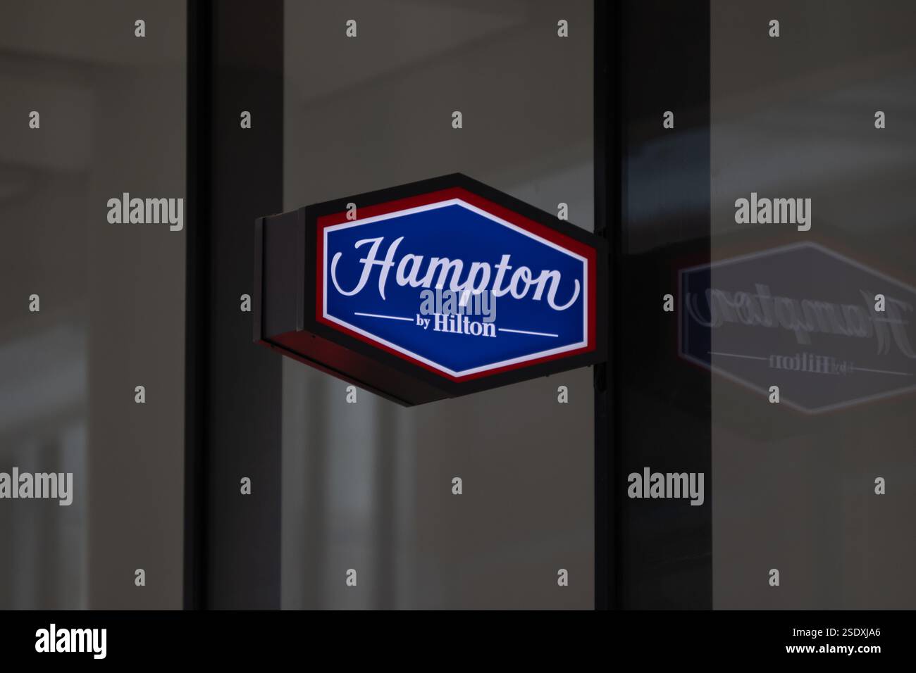 Hampton by Hilton hotel sign. Logo is reflecting in the window Stock ...