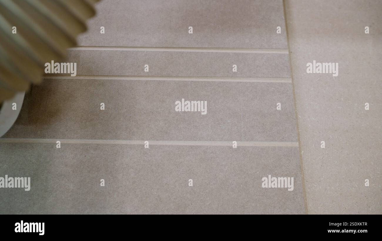 Modern cnc machine cutting grooves in wood panel during manufacturing ...