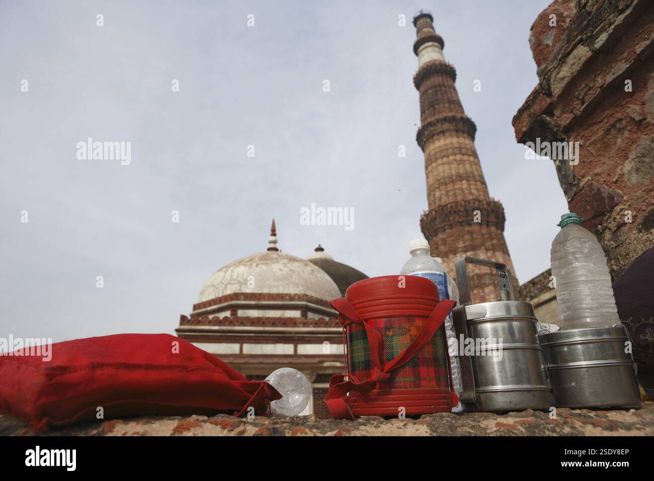 Lunch Tiffin boxes and water bottles in Qutab Minar built in 1311 red ...