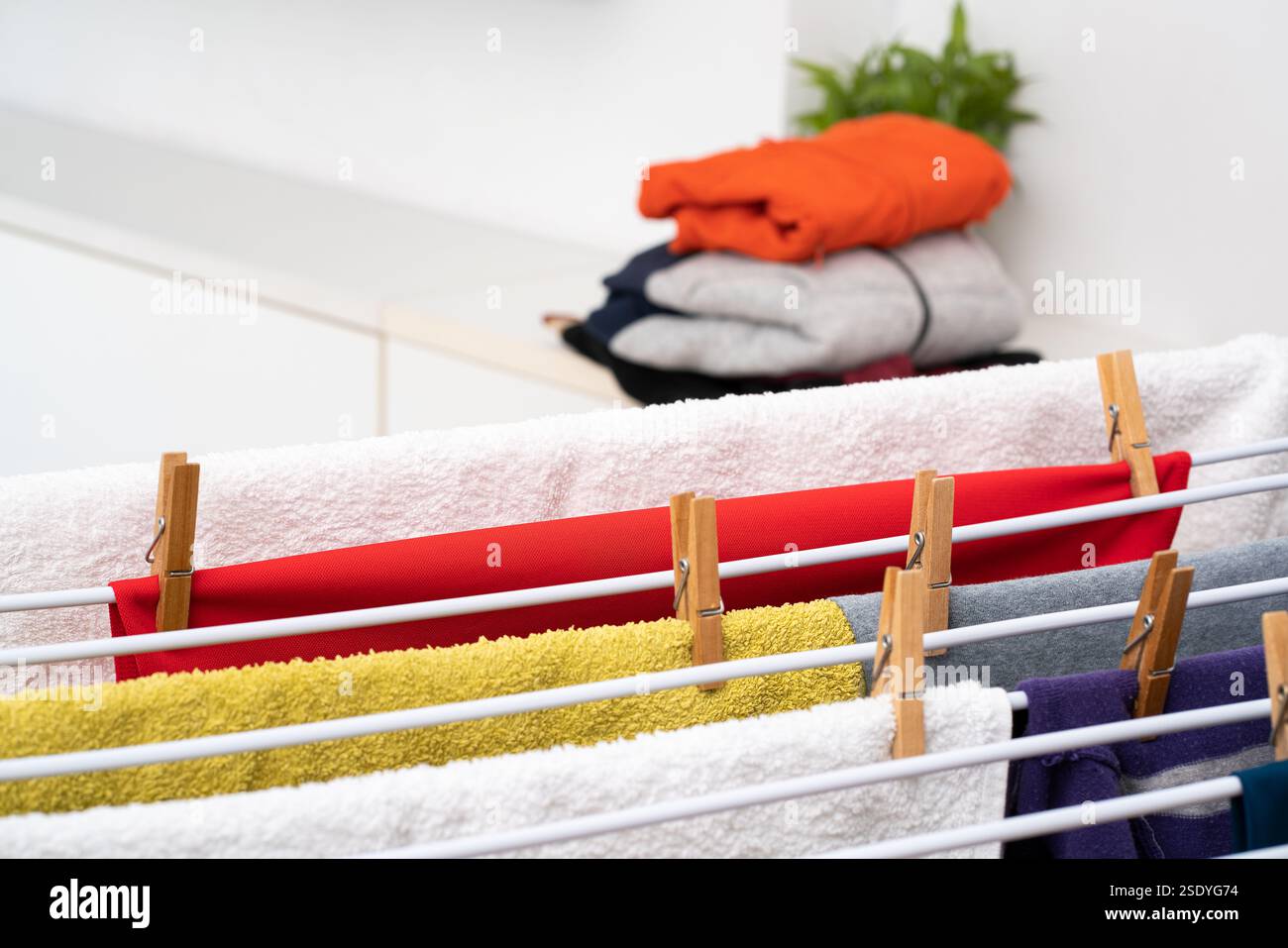 Close up of clean laundry hanging on drying rack indoors at house Stock ...