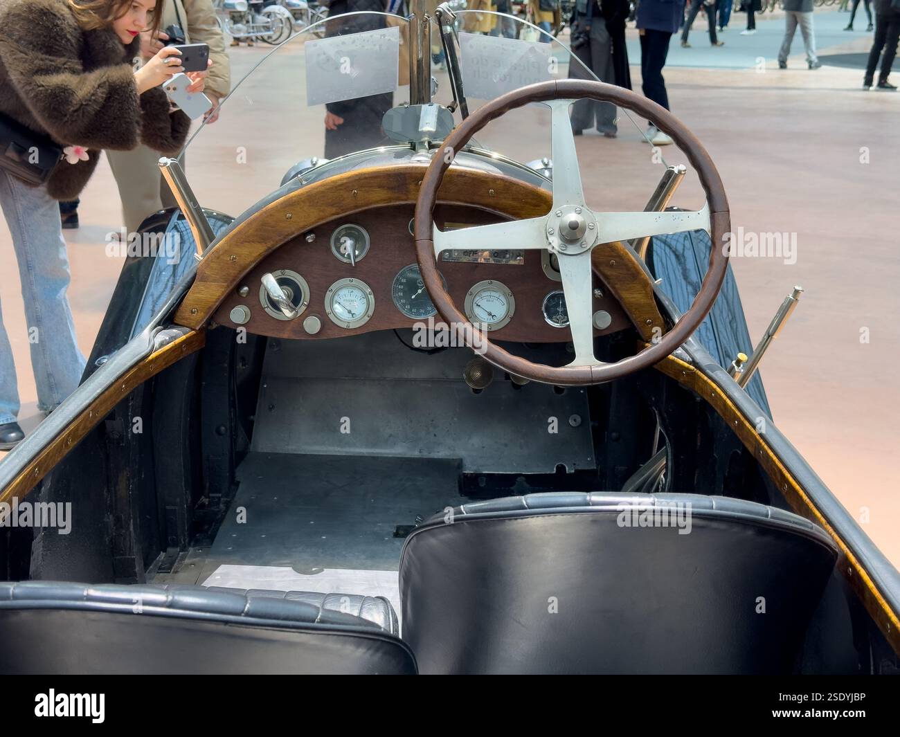 Classic car interior with vintage steering wheel at an auto exhibition ...