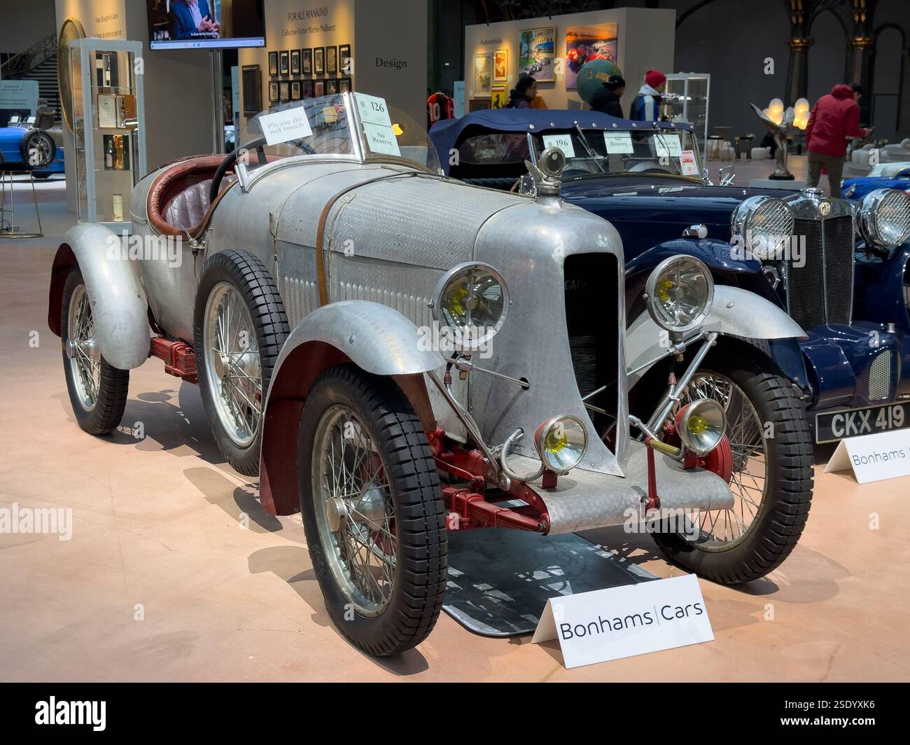 Classic vintage car showcased at an auto exhibition in a busy ...