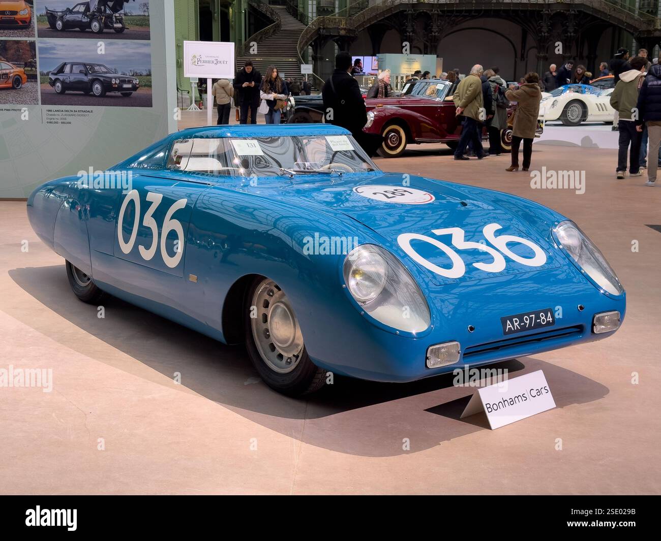 Classic racing car displayed at an automotive exhibition in grand hall ...