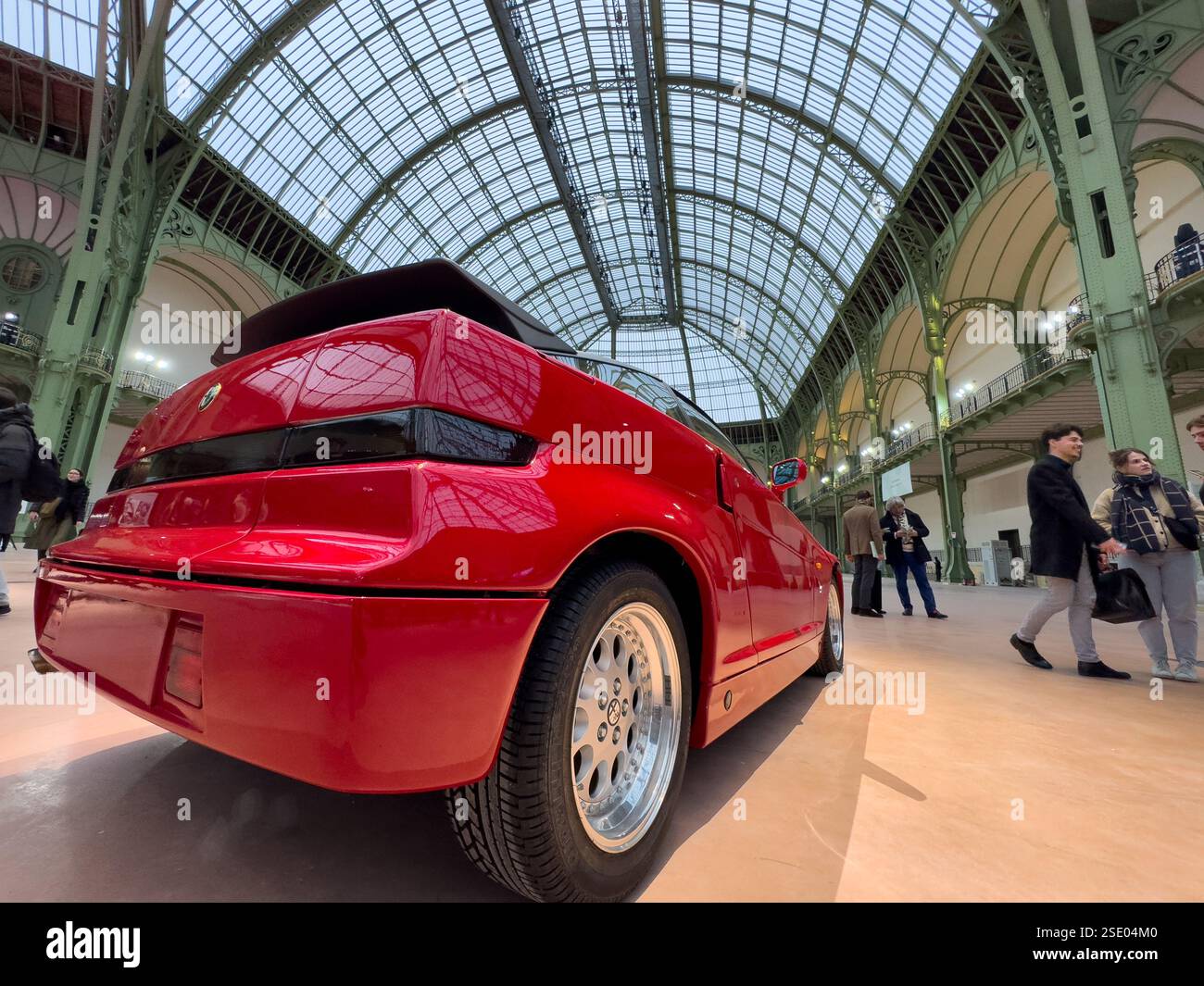 Unique red sports car showcased in a stunning glass-roofed venue Stock ...