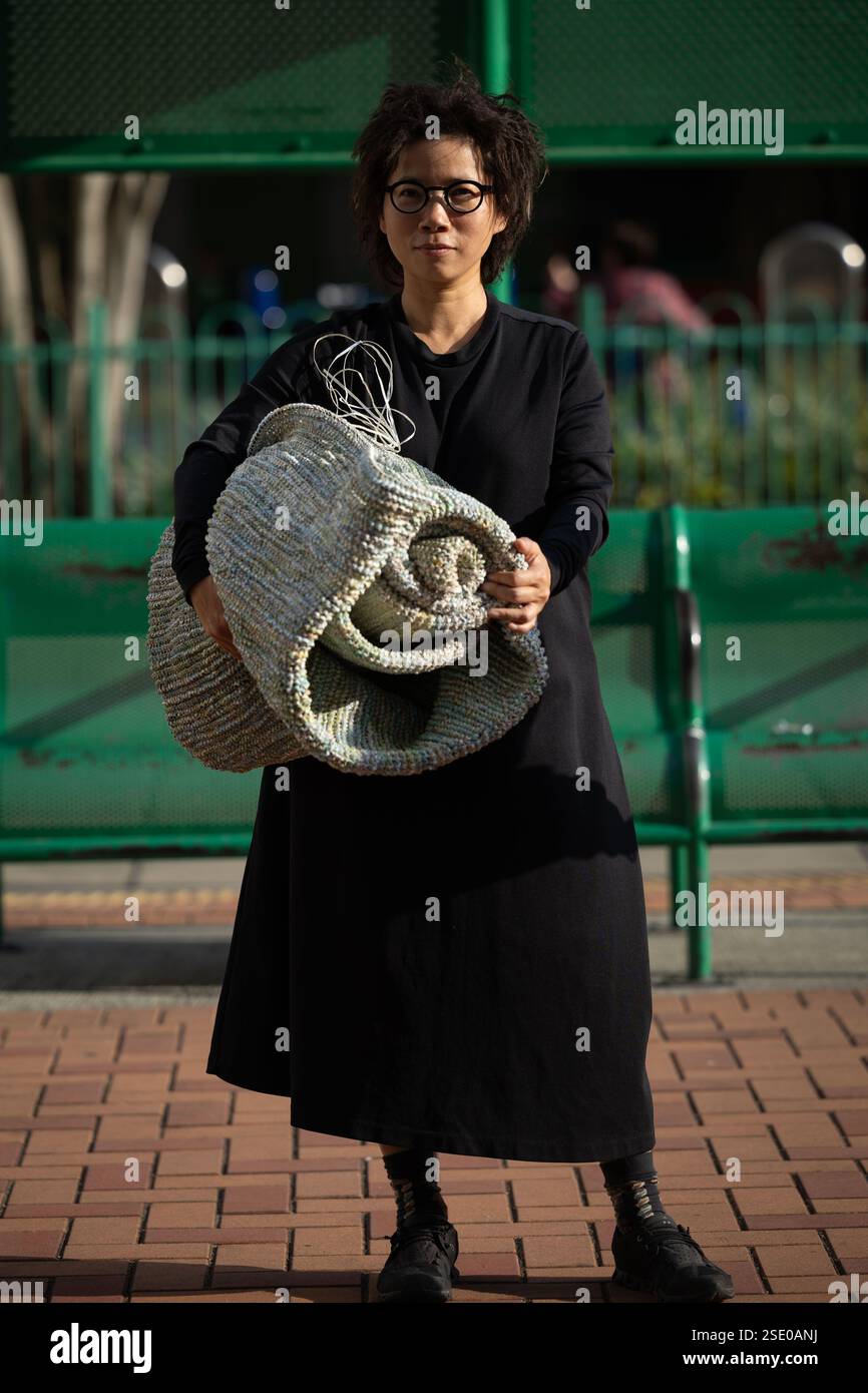 A portrait of Movana Chen with her art piece body container. Movana ...