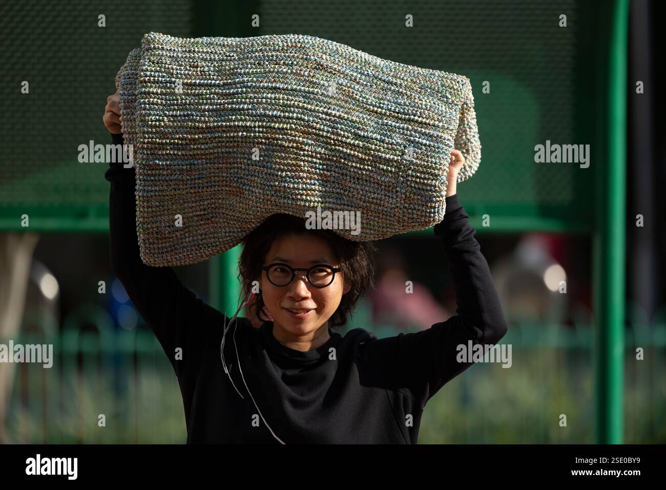 A portrait of Movana Chen with her art piece body container. Movana ...