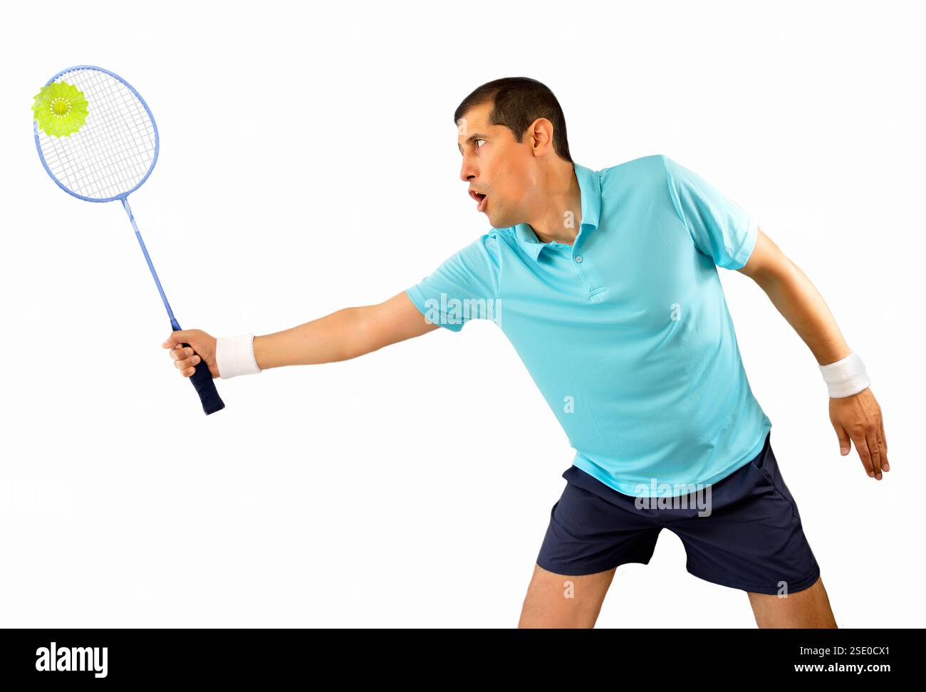portrait of a young male badminton player standing and swatting the ...