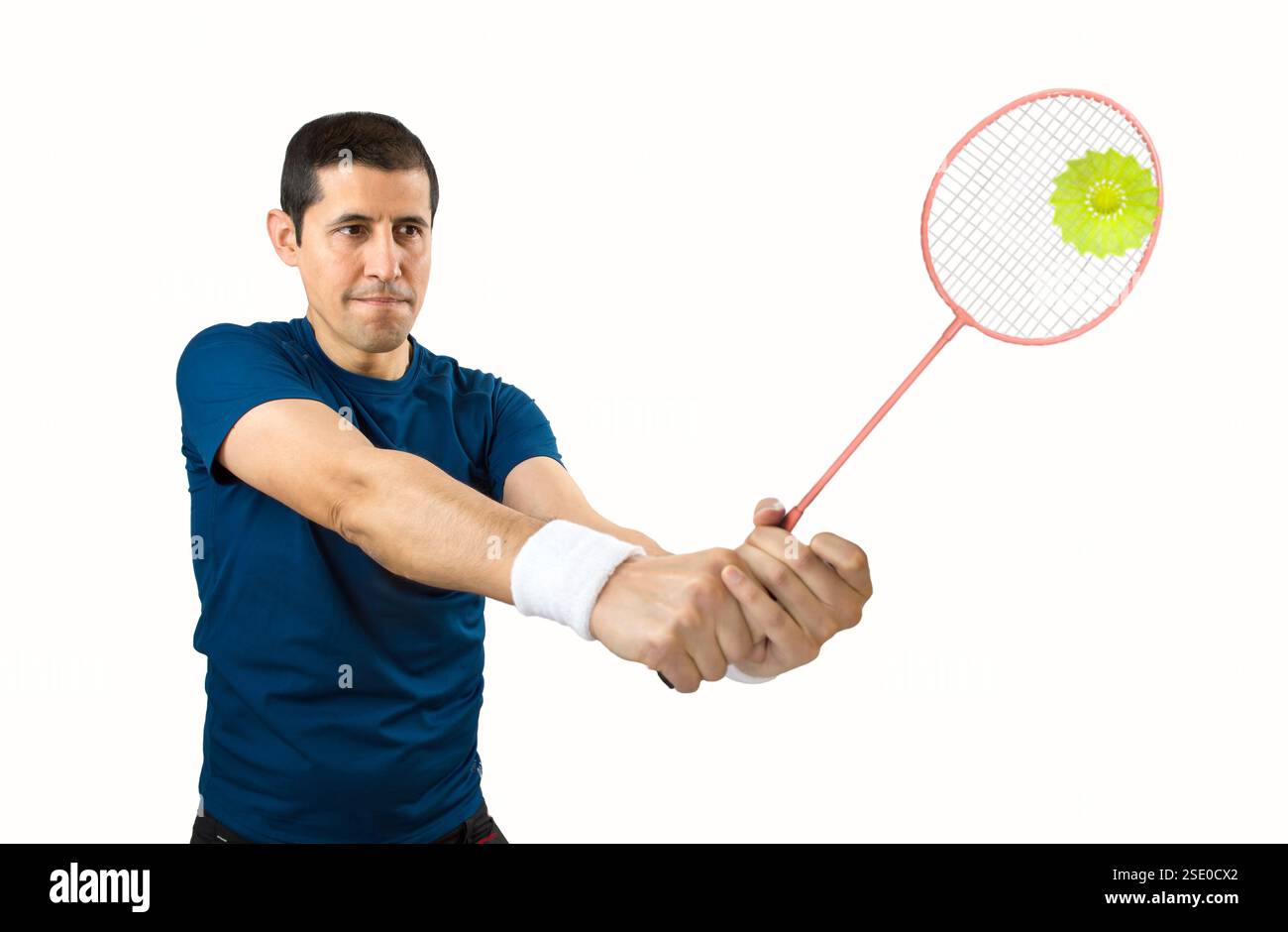 portrait of a young male badminton player standing and swatting the ...