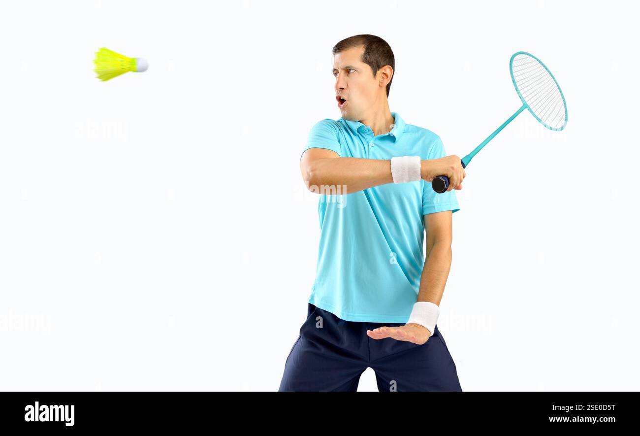 portrait of a young male badminton player standing and swatting the ...