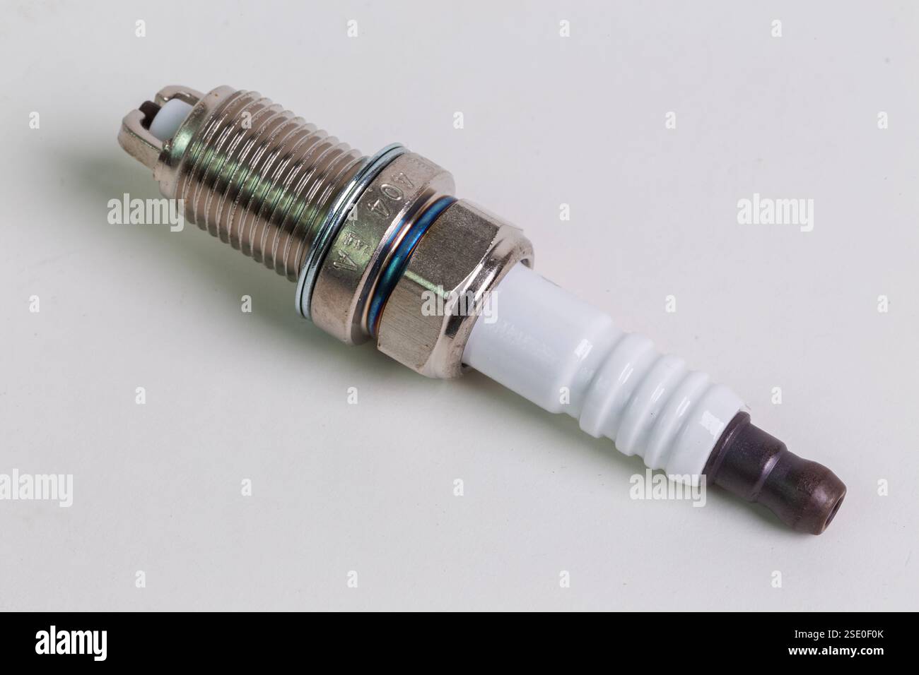 The sparking plug on a white background Stock Photo - Alamy