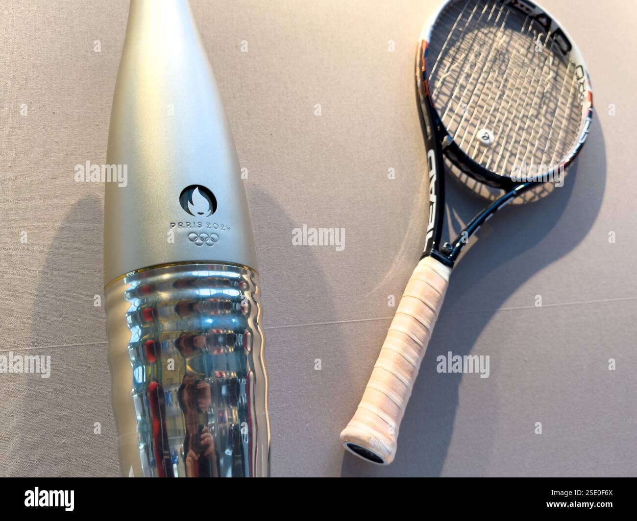 Golden trophy and tennis racket on display in Paris Olympic venue Stock ...