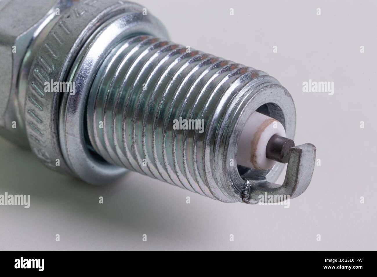 The sparking plug on a white background Stock Photo - Alamy