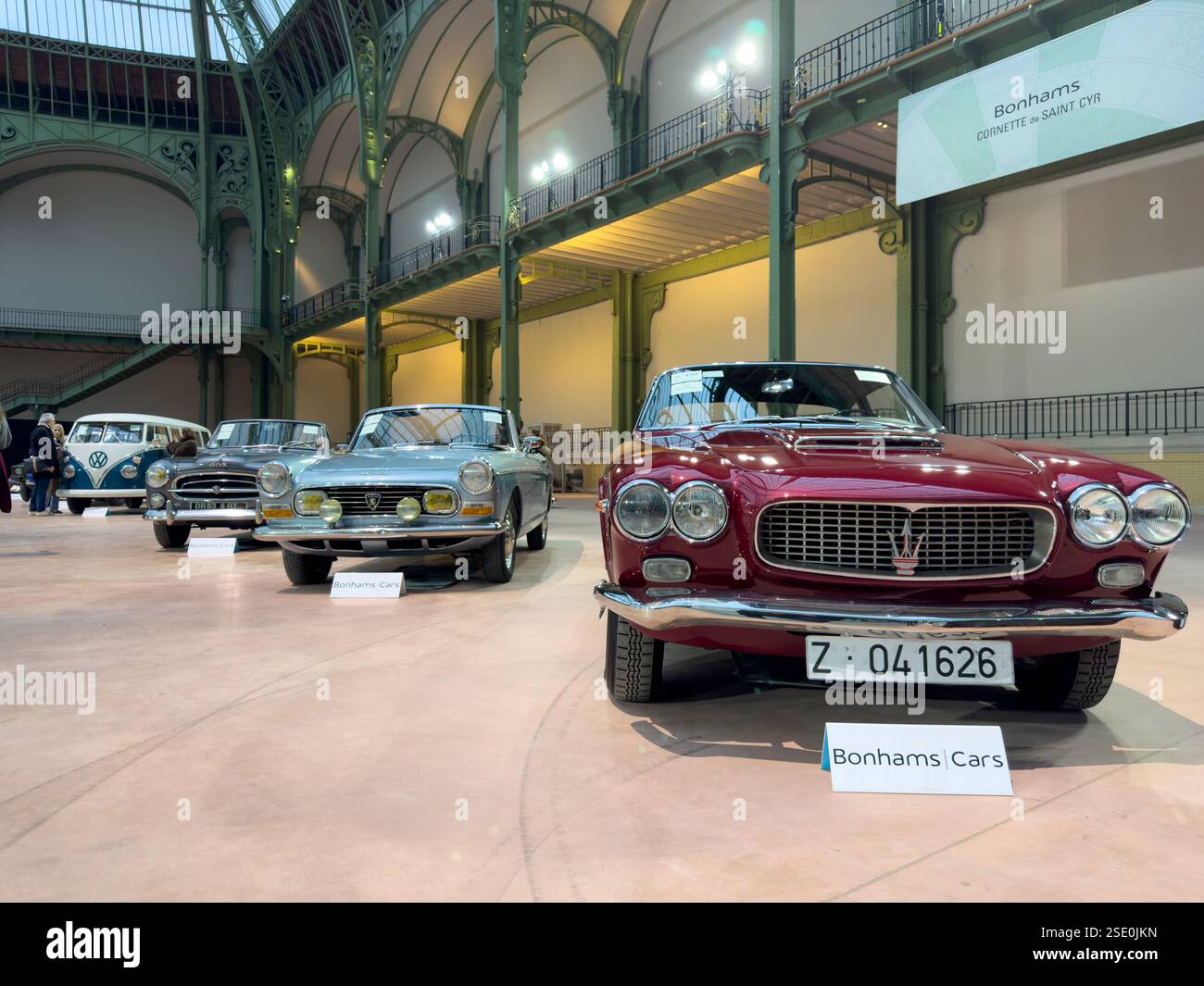 Classic cars showcase at a vibrant auction in a historic Parisian venue ...