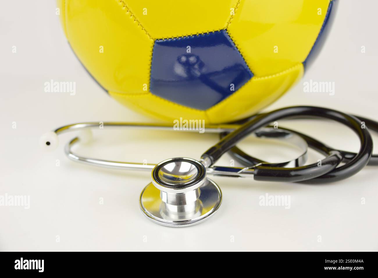 soccer yellow ball and stethoscope in the studio isolated on white ...