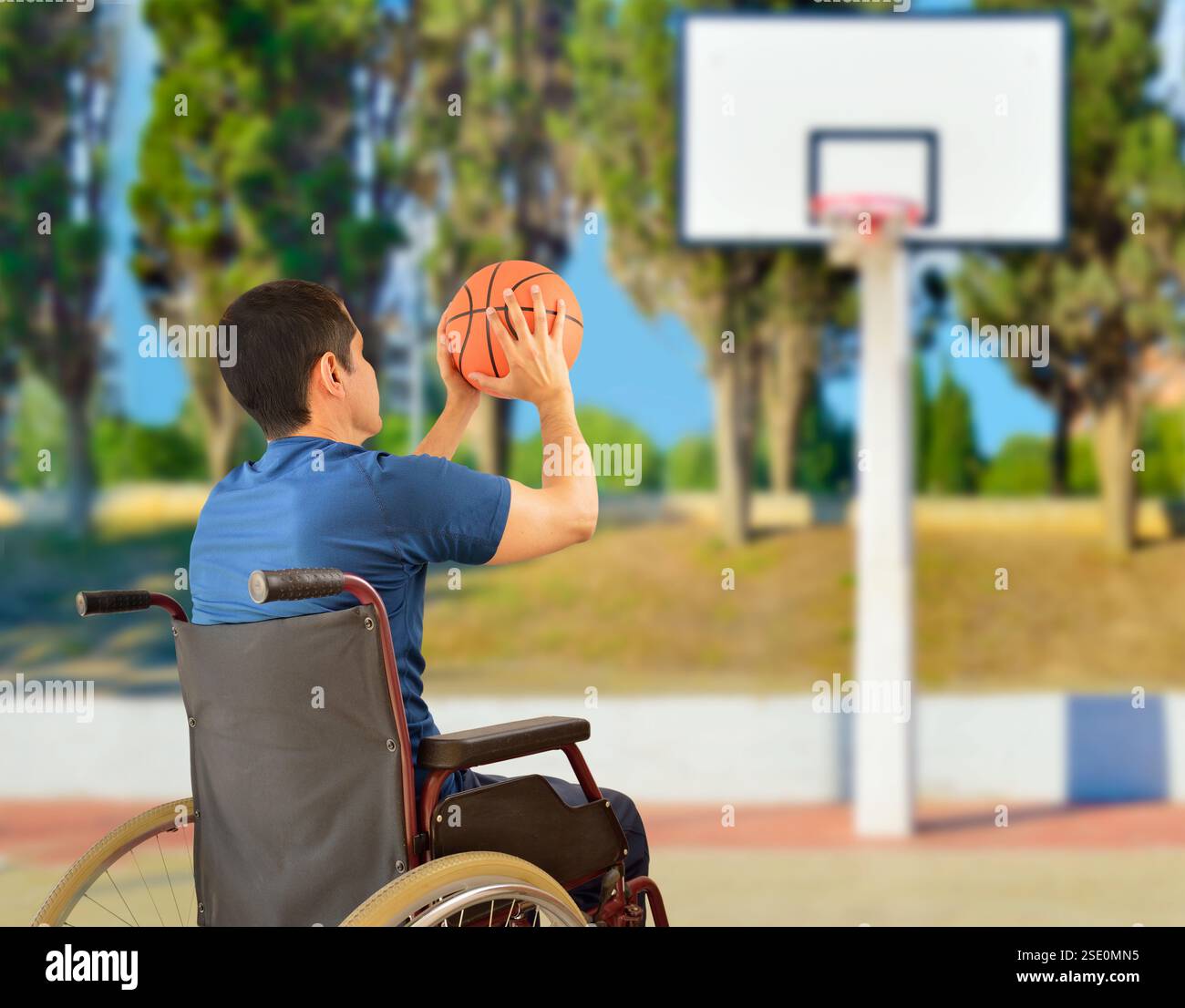 rear view of a basketball player in free throw pose in wheelchair at ...