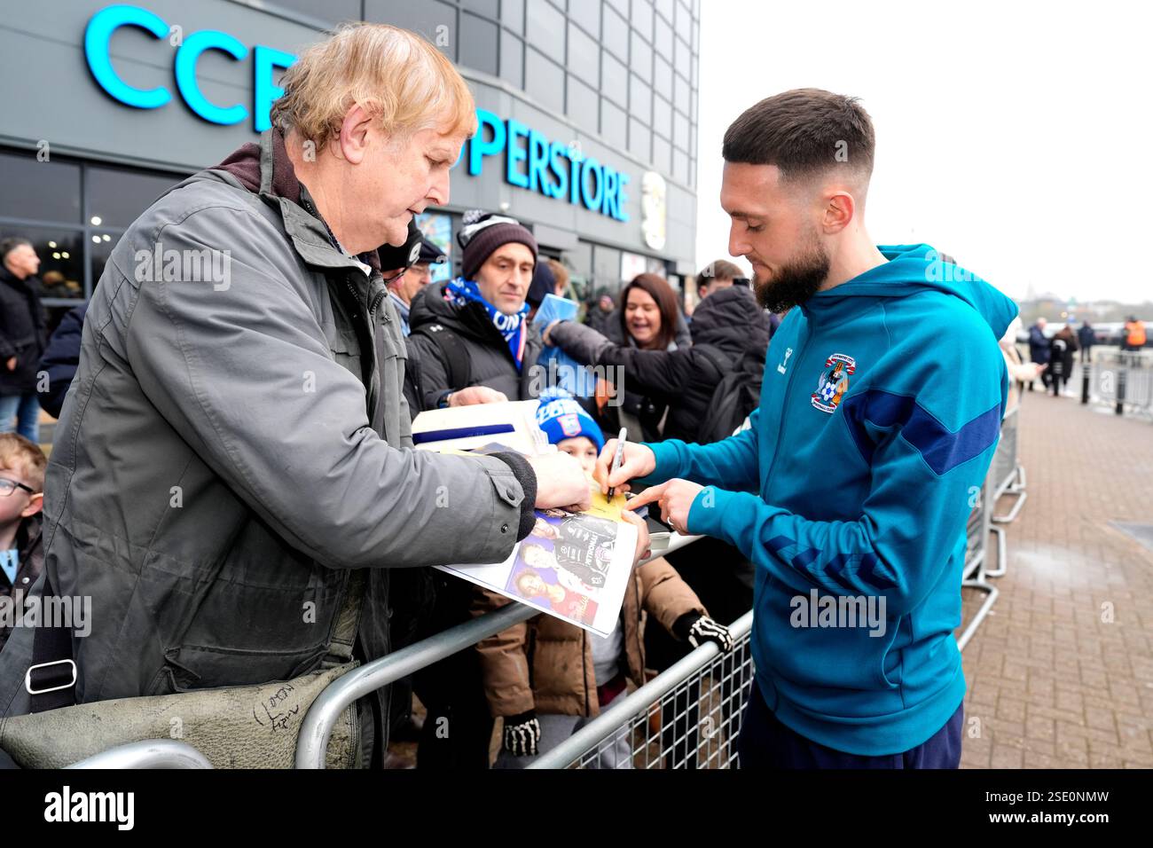 Coventry City's Matt Grimes signs autographs for fans outside the ...