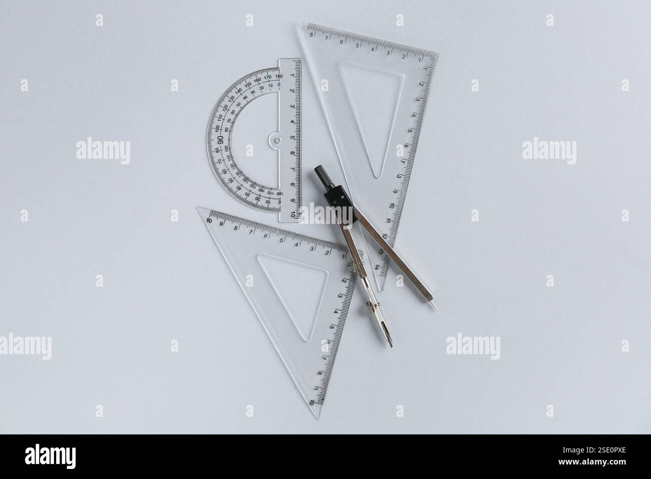 Rulers and compass on light grey background, flat lay Stock Photo - Alamy