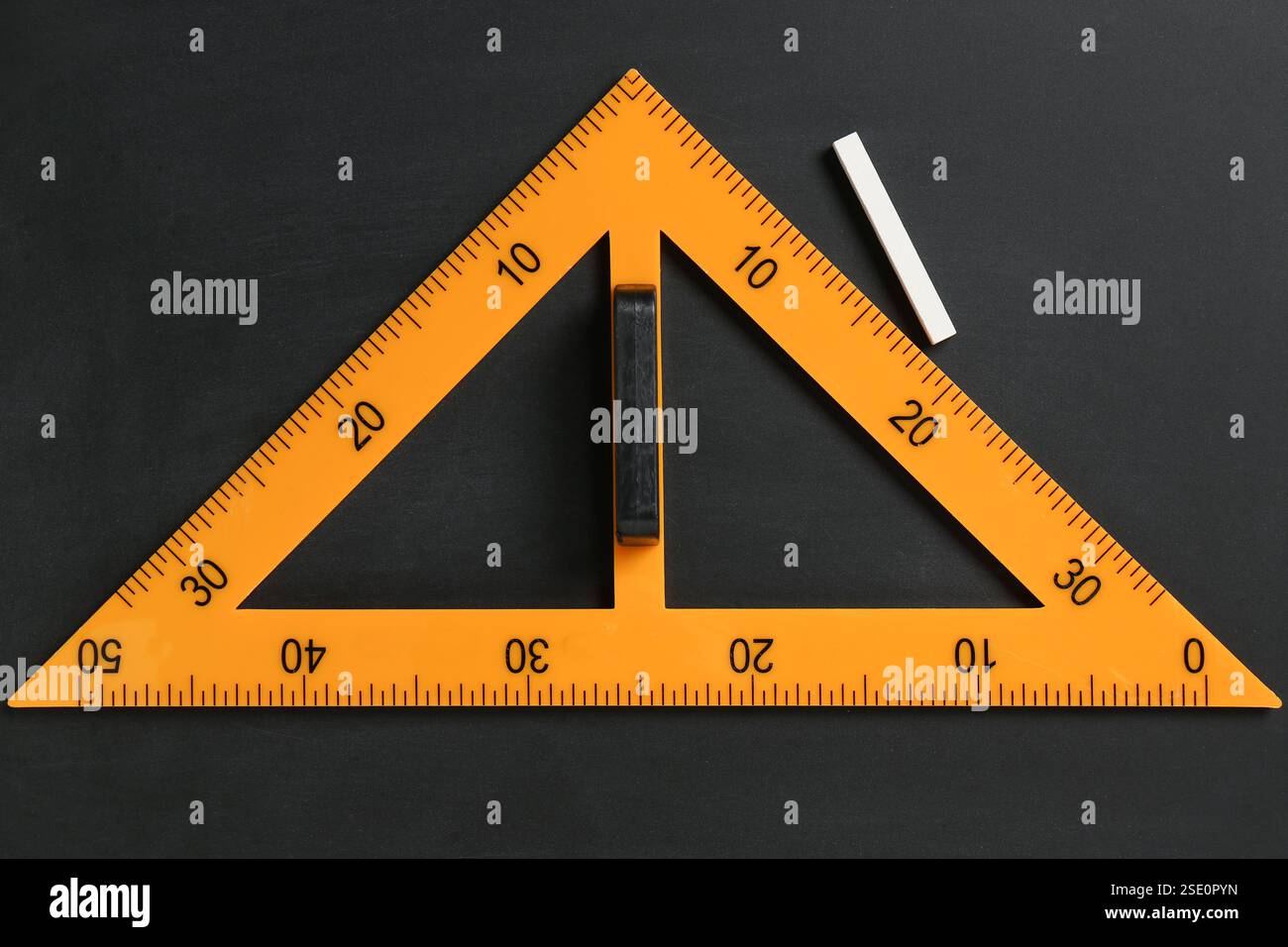 Triangle ruler and chalk on black chalkboard, top view Stock Photo - Alamy