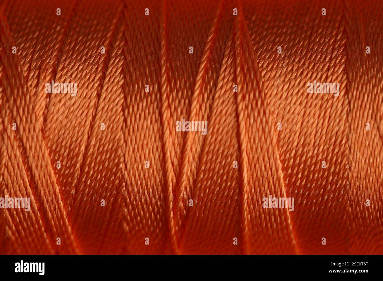 Spool of orange sewing thread as background, closeup Stock Photo - Alamy