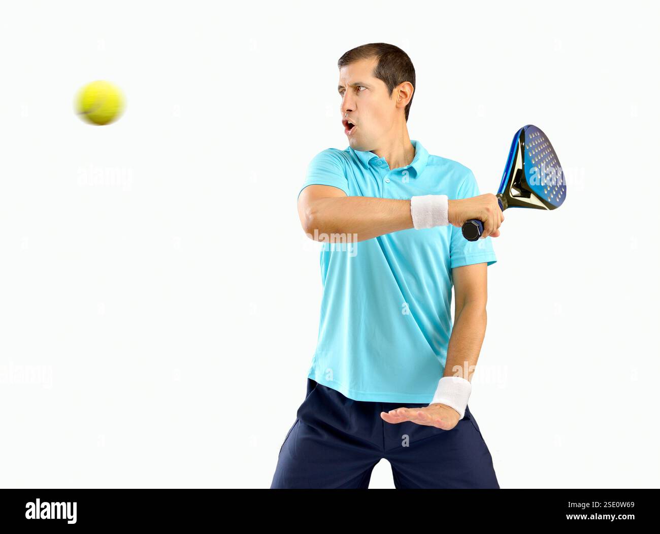 portrait of a male paddle tennis player with racket ready to hit the ...