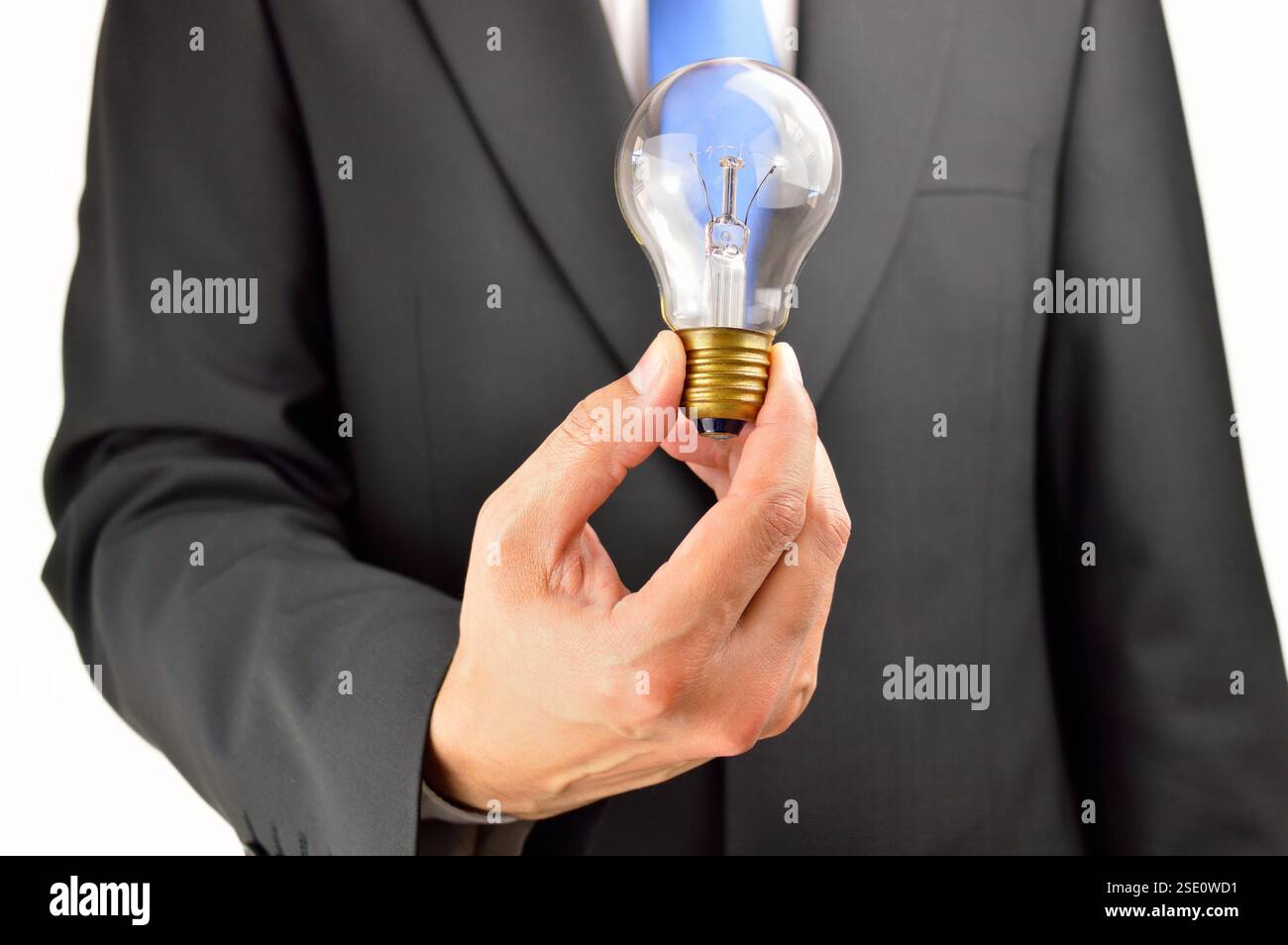 Business man showing a light bulb as idea work concept Stock Photo - Alamy