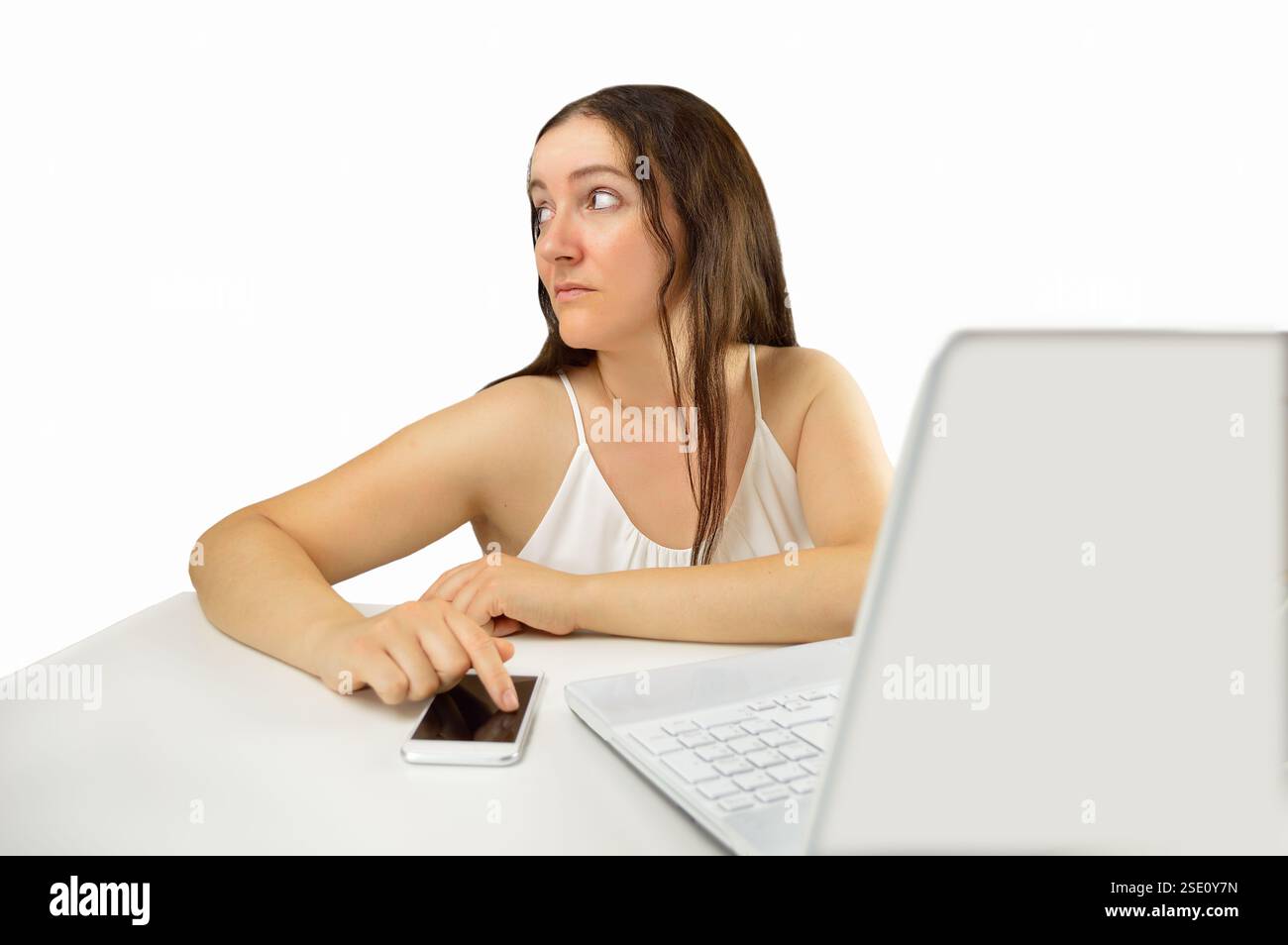 Lazy female employee playing games with her smartphone sitting in a ...