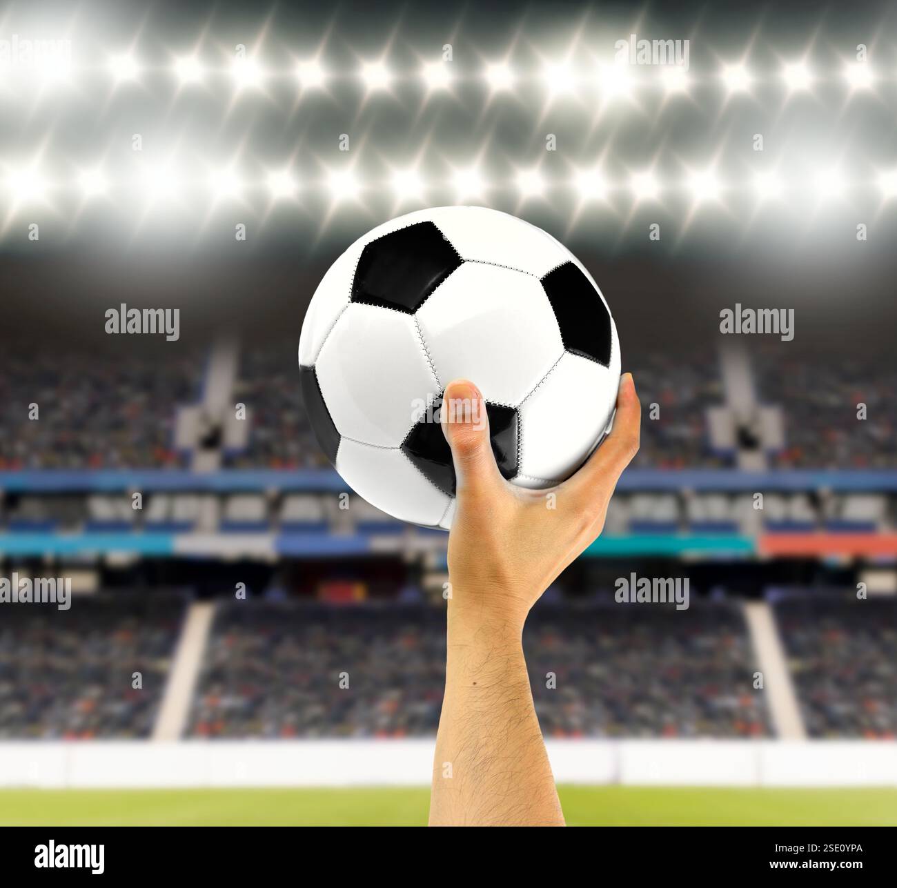 Classic soccer ball in hand of man at stadium Stock Photo - Alamy