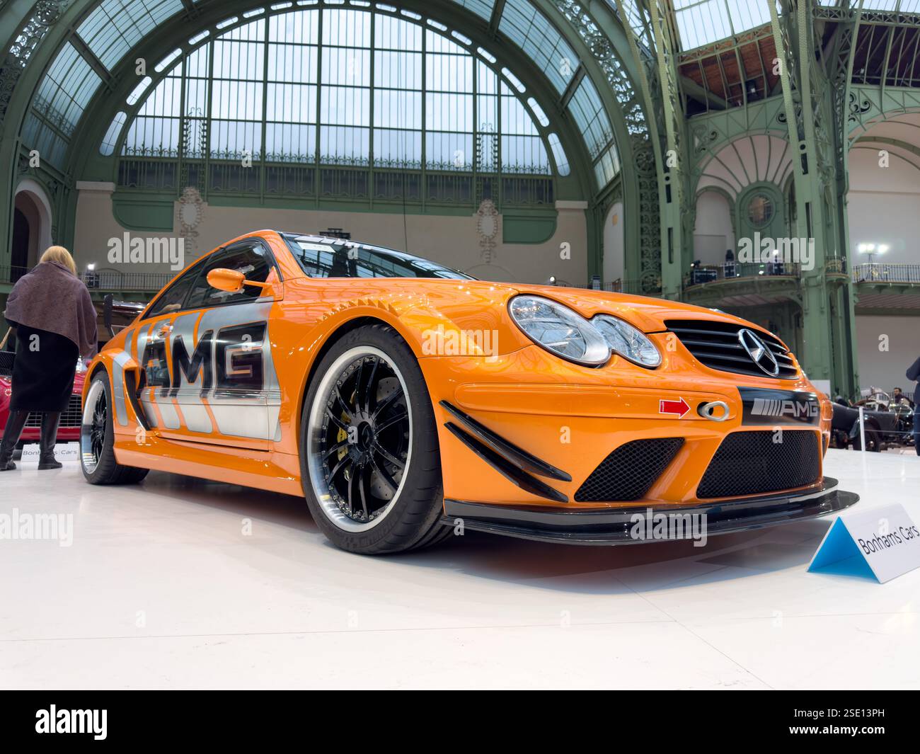 Bright orange racing car on display in an elegant exhibition hall Stock ...