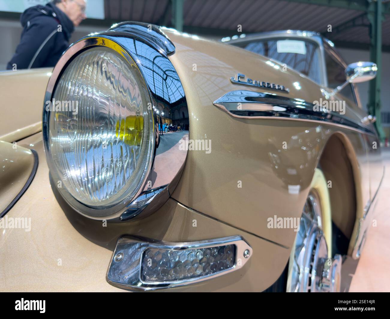 Classic vintage car showcased at an auto exhibition in a bustling ...