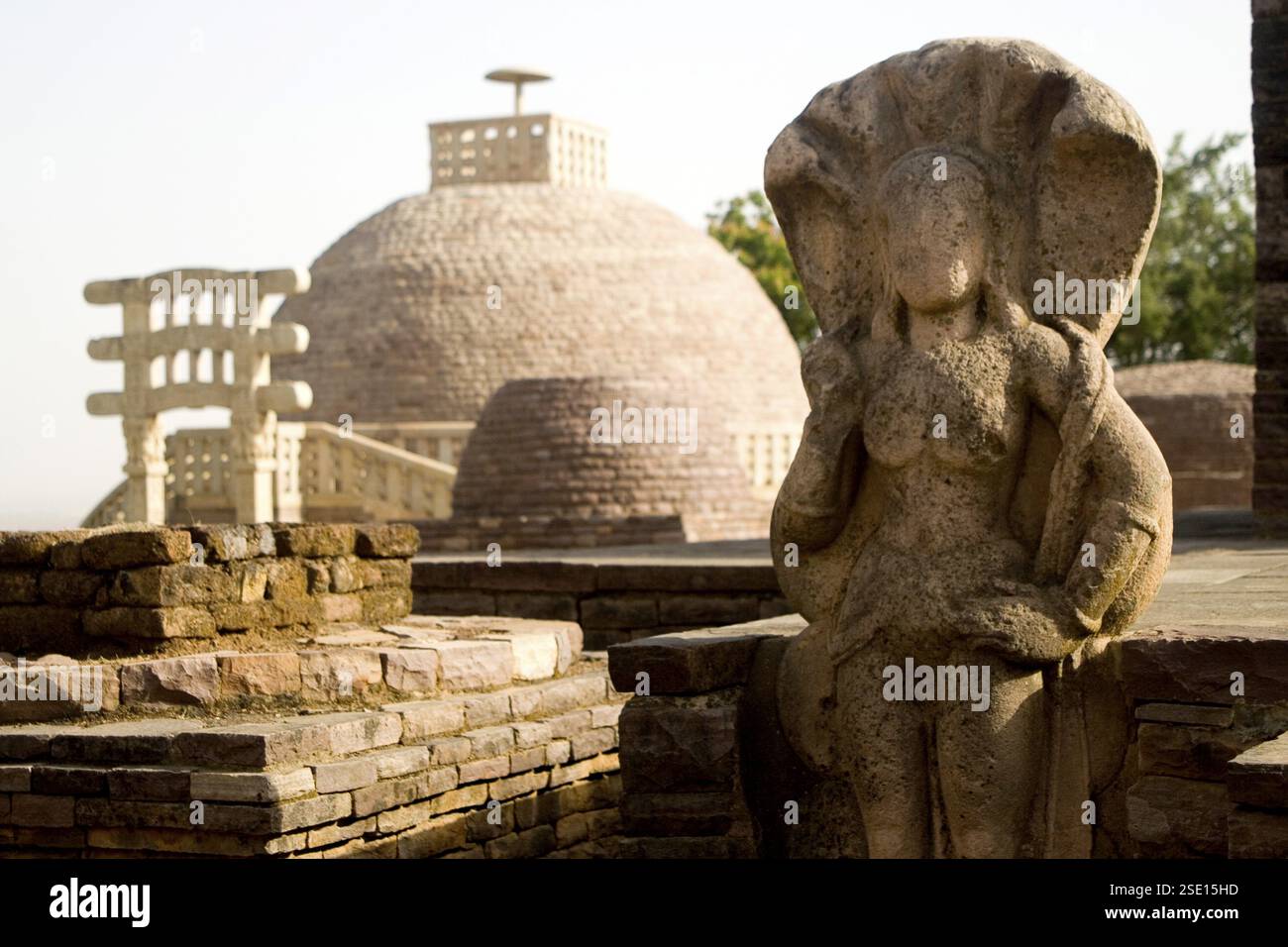 Nagi figure standing against southern face of platform to west of ...