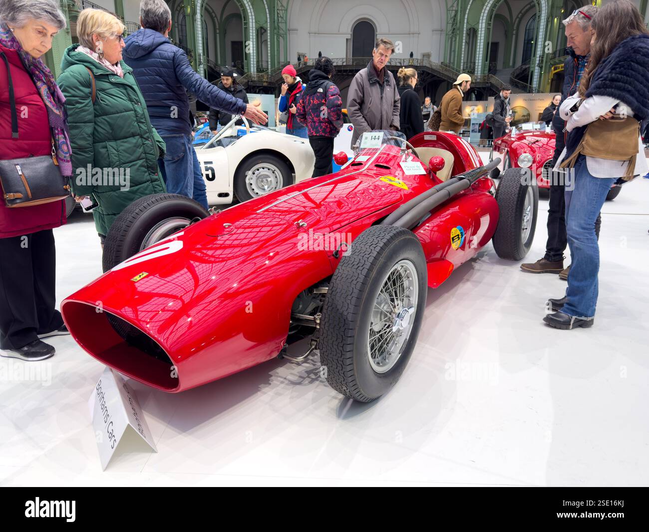 Vintage race car enthusiasts admire classic Ferrari at automotive ...