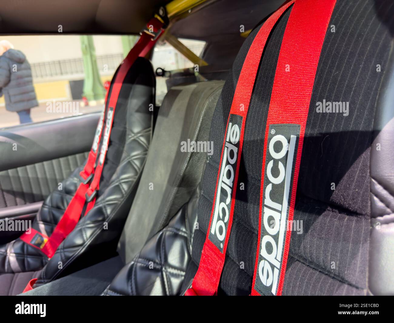Racing seat belts in a modified car interior during a sunny afternoon ...