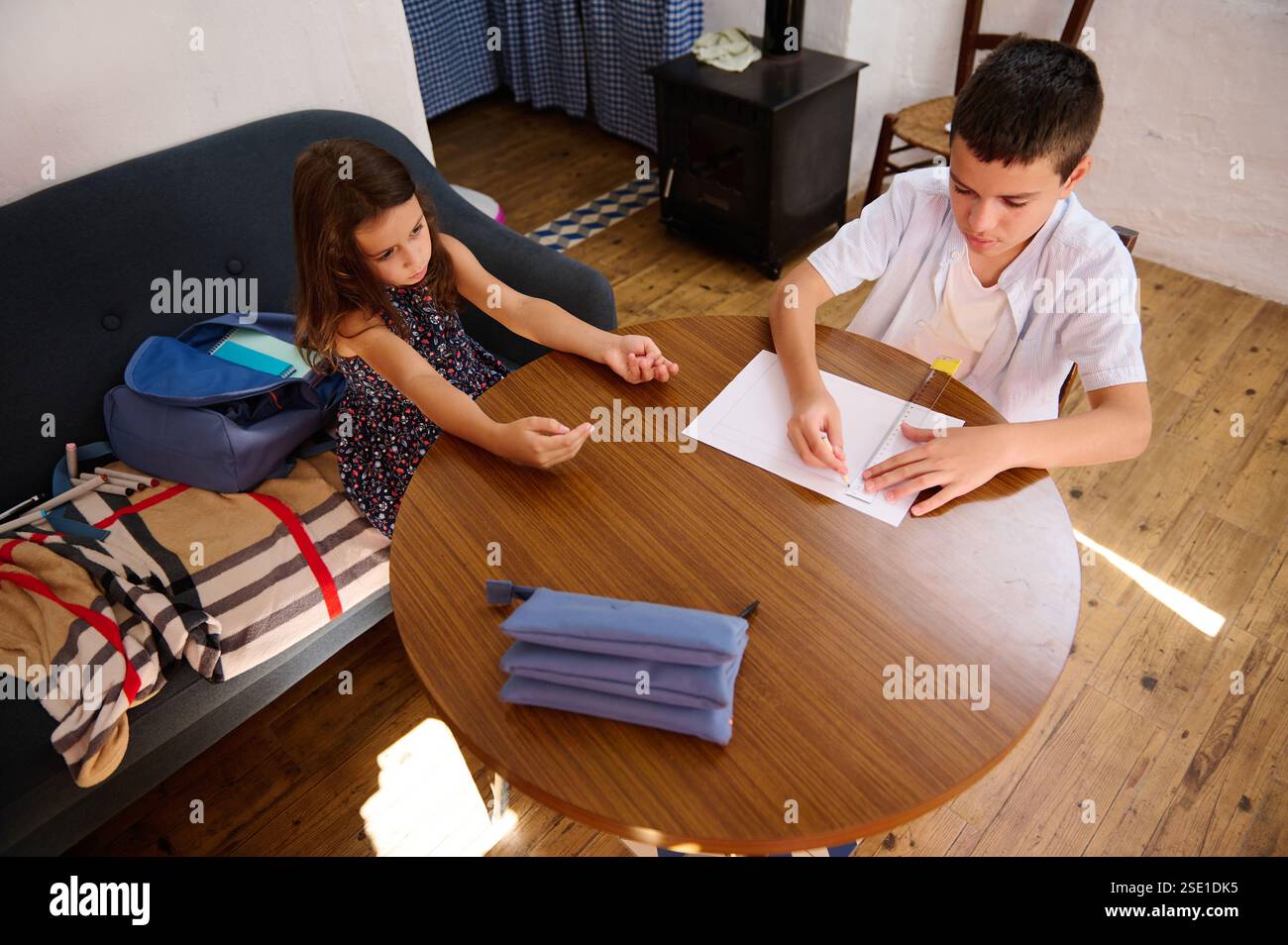 Two children working together at a table on homework tasks, fostering ...