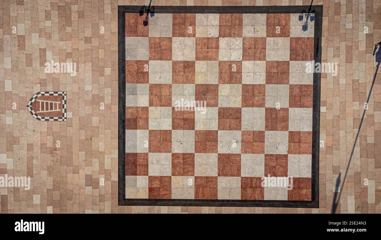 Large chessboard seen from above. Chess square in the center of ...