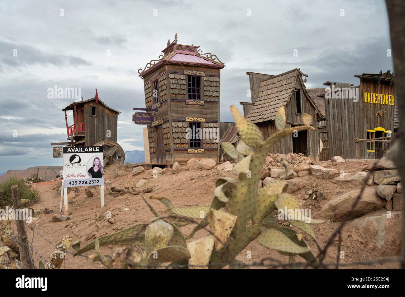 Real estate sign at a Wild West-themed attraction. Buildings include ...