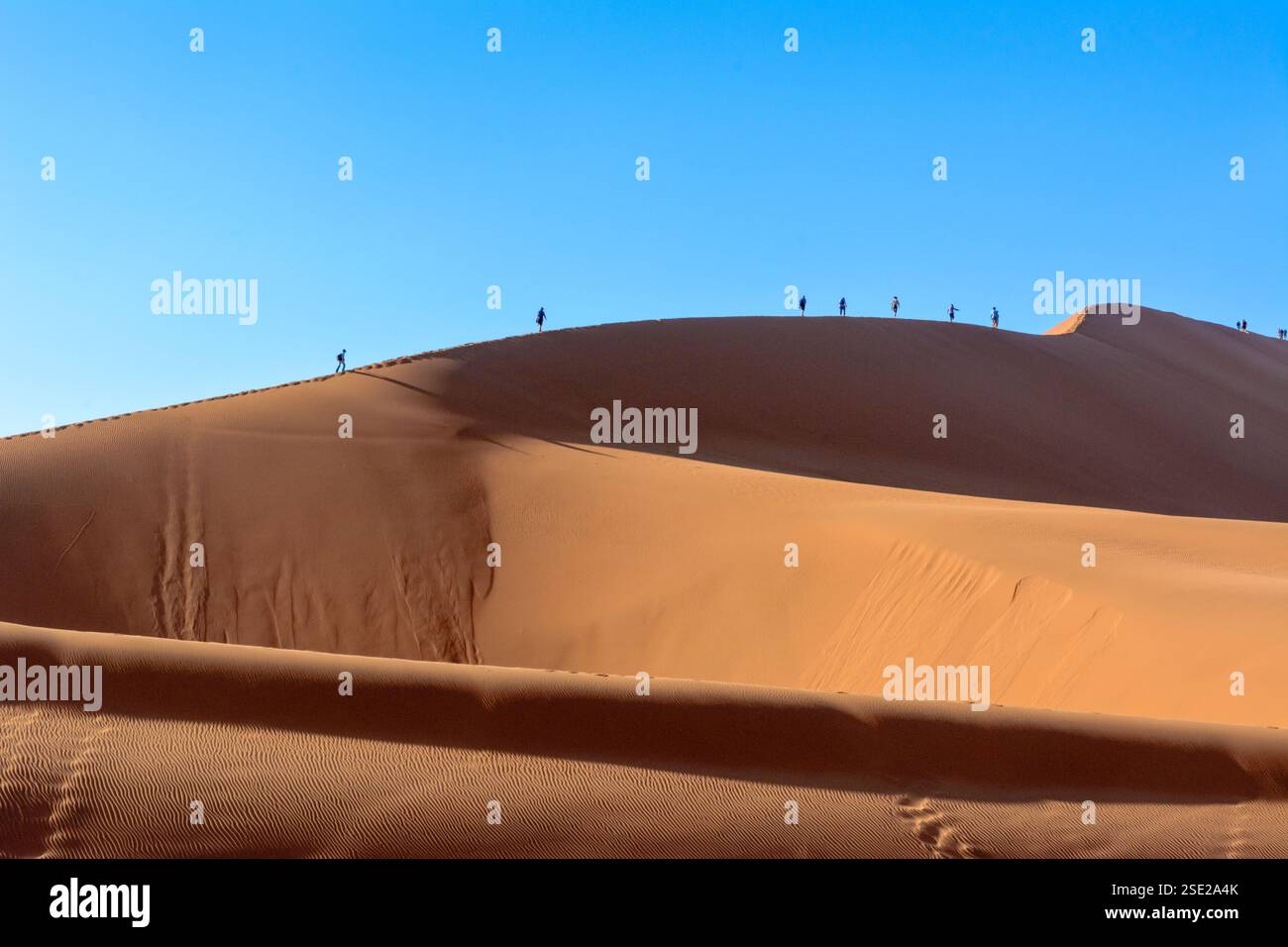 People climbing Big Daddy or Crazy Dune, the tallest sand dune between ...