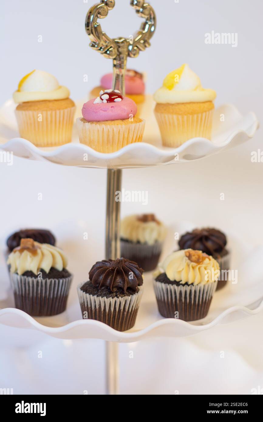 Chocolate, strawberry and lemon cupcakes on a traditional cake stand ...