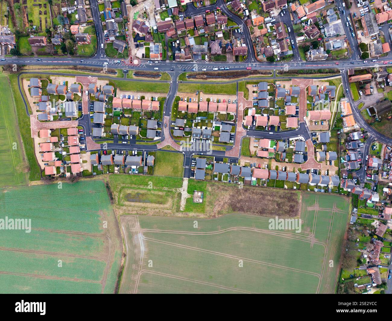 Aerial top down view above a block of newly built affordable suburban ...