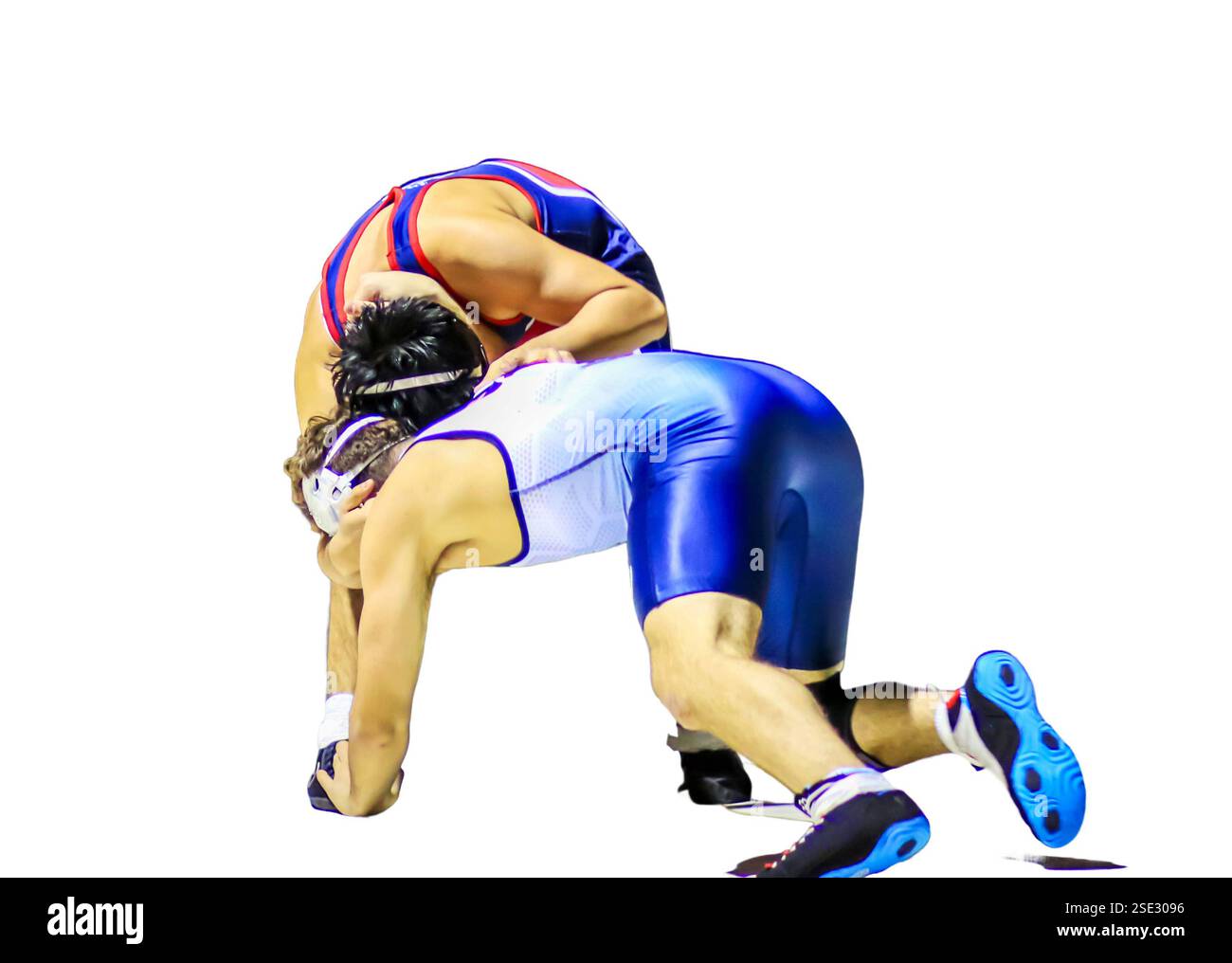 Two wrestlers compete on the mat, showcasing strength and skill in an ...