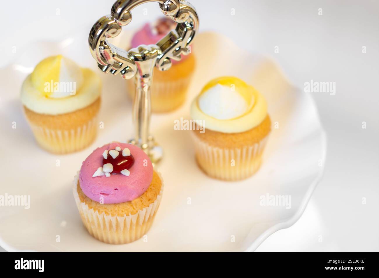 Strawberry and lemon cupcakes on a traditional cake stand for Easter ...