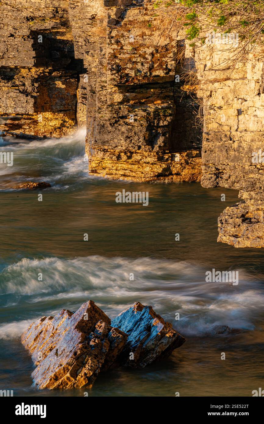 Waves crash the Cave Point Lake Michigan shore at sunrise, Cave Point ...