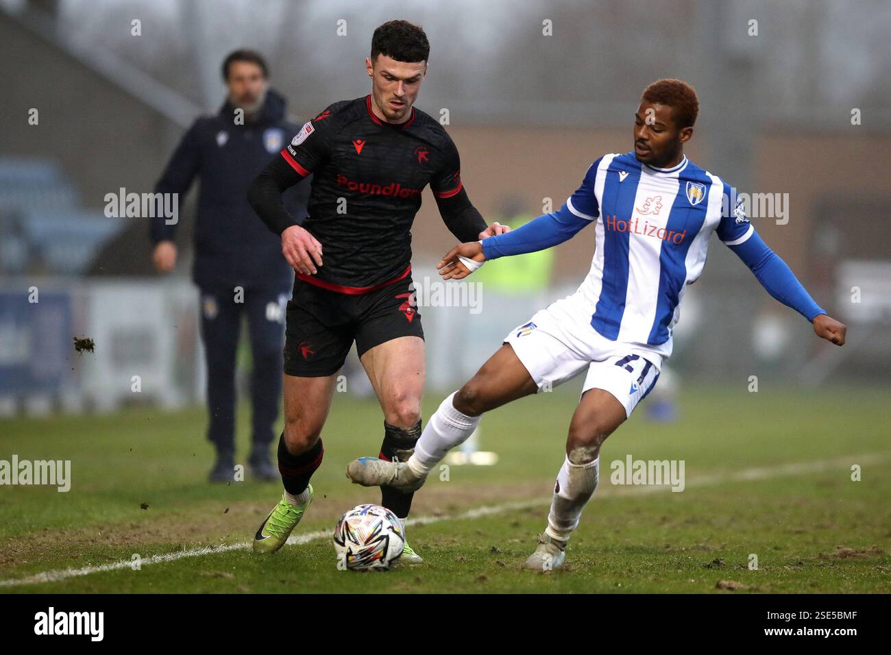Walsall's Connor Barrett battles for the ball against Colchester United ...