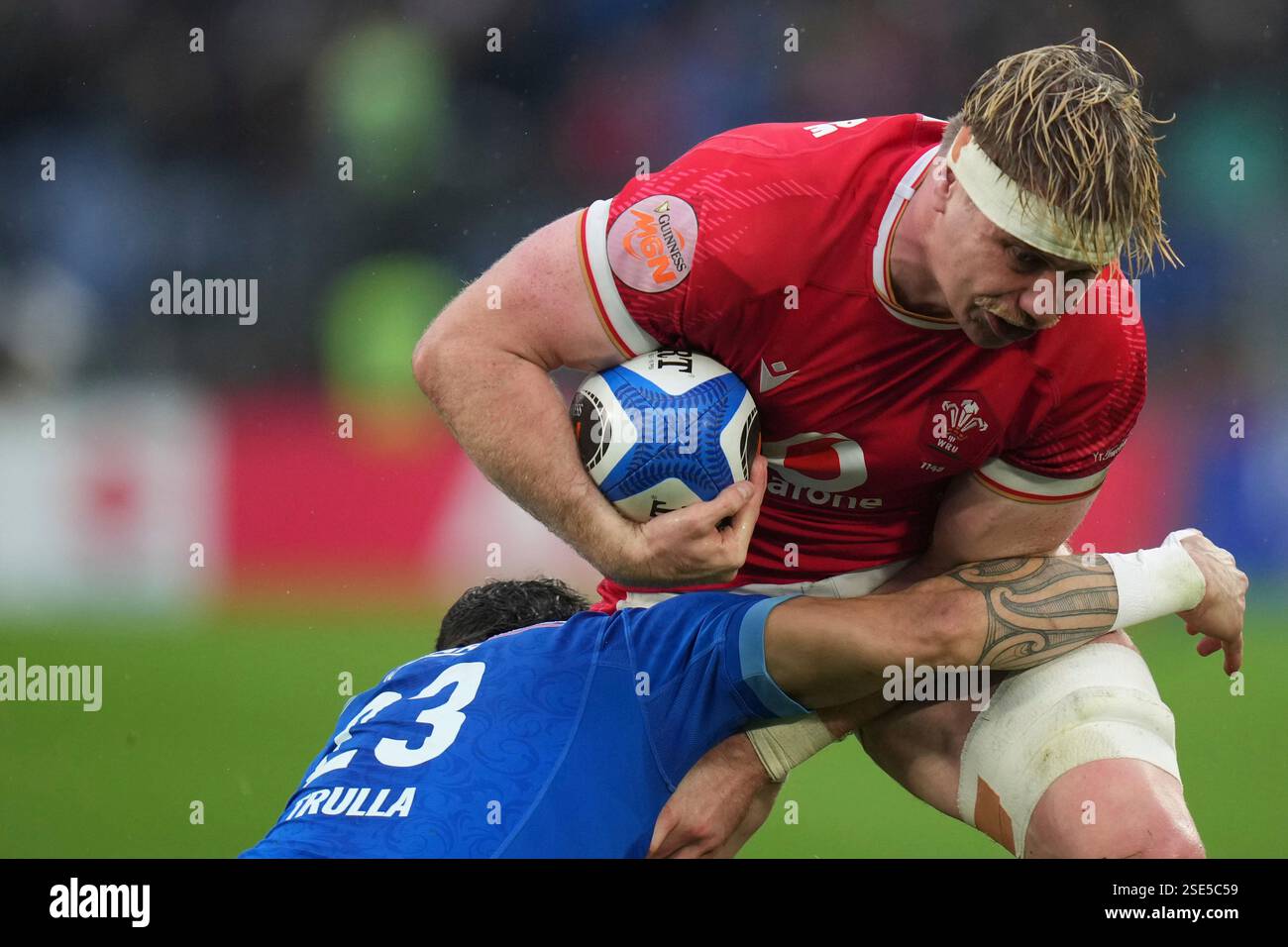 Wale's Aaron Wainwright, right, is tackled by Italy's Jacopo Trulla ...