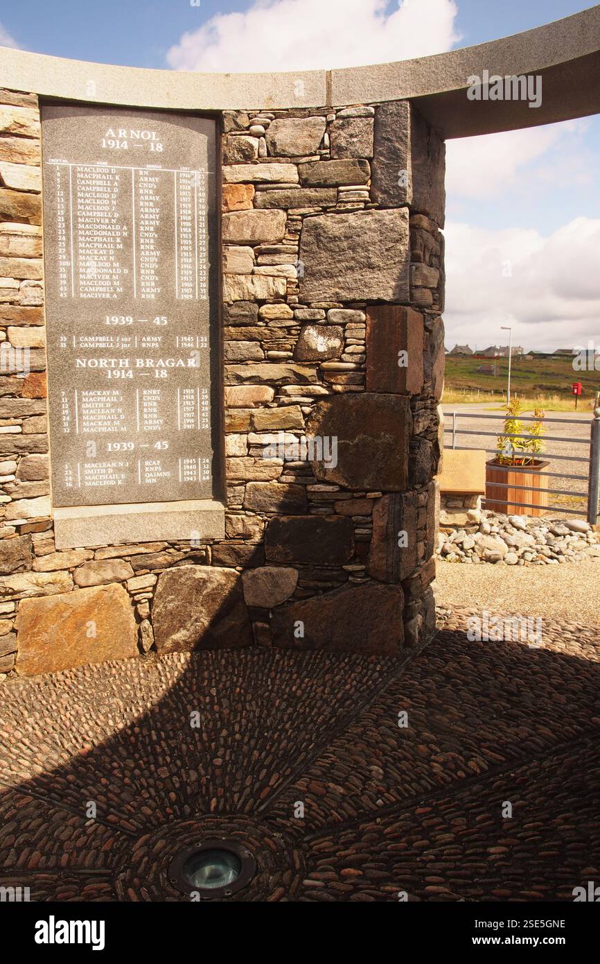 A modern, circular war memorial set in the village of Bragar, Isle of ...