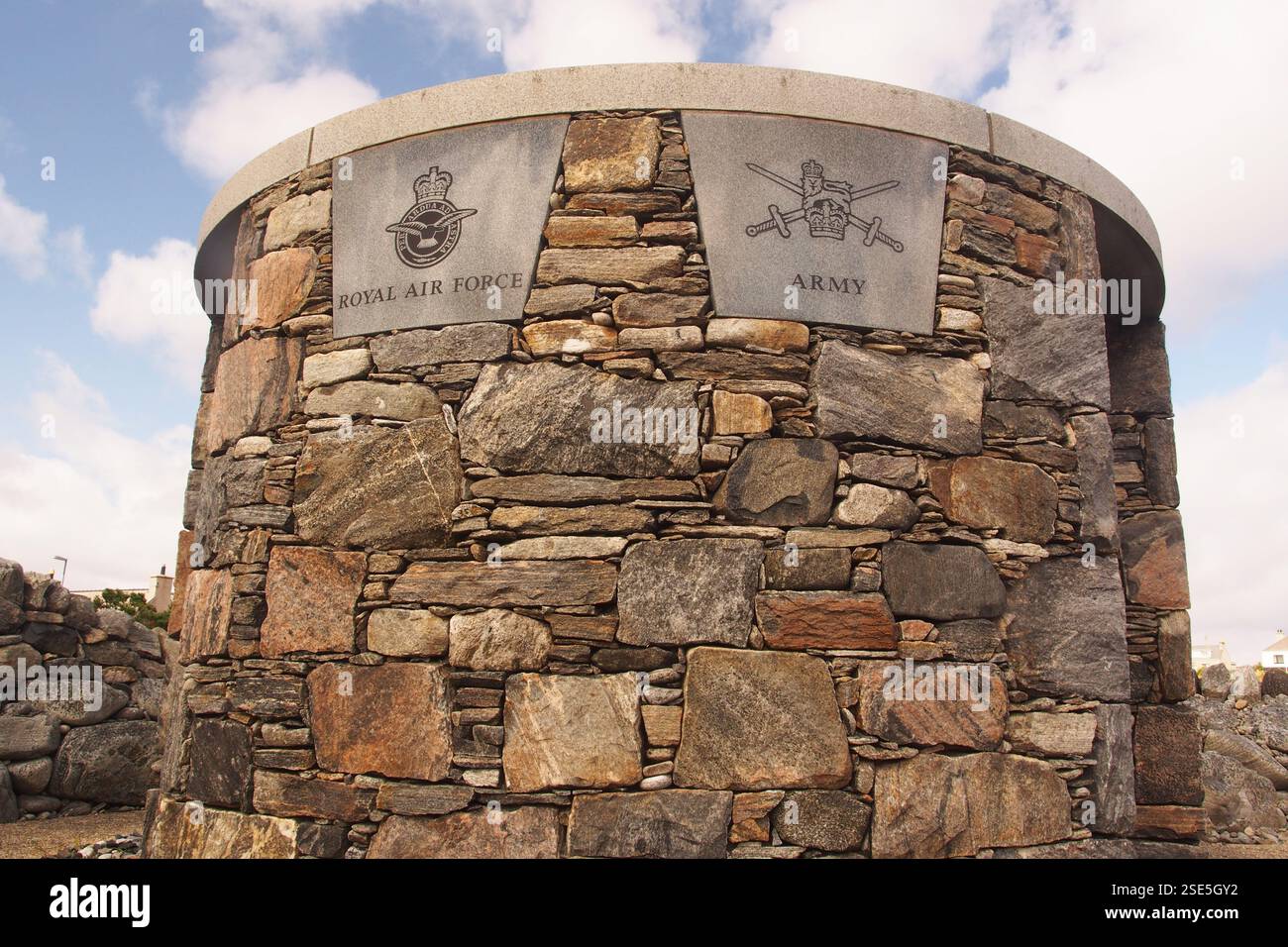 A modern, circular war memorial set in the village of Bragar, Isle of ...