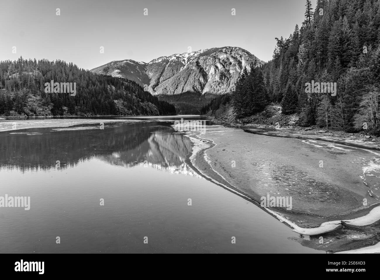 A landscape shot of the Skagit River in winter. with a layer of ice on ...