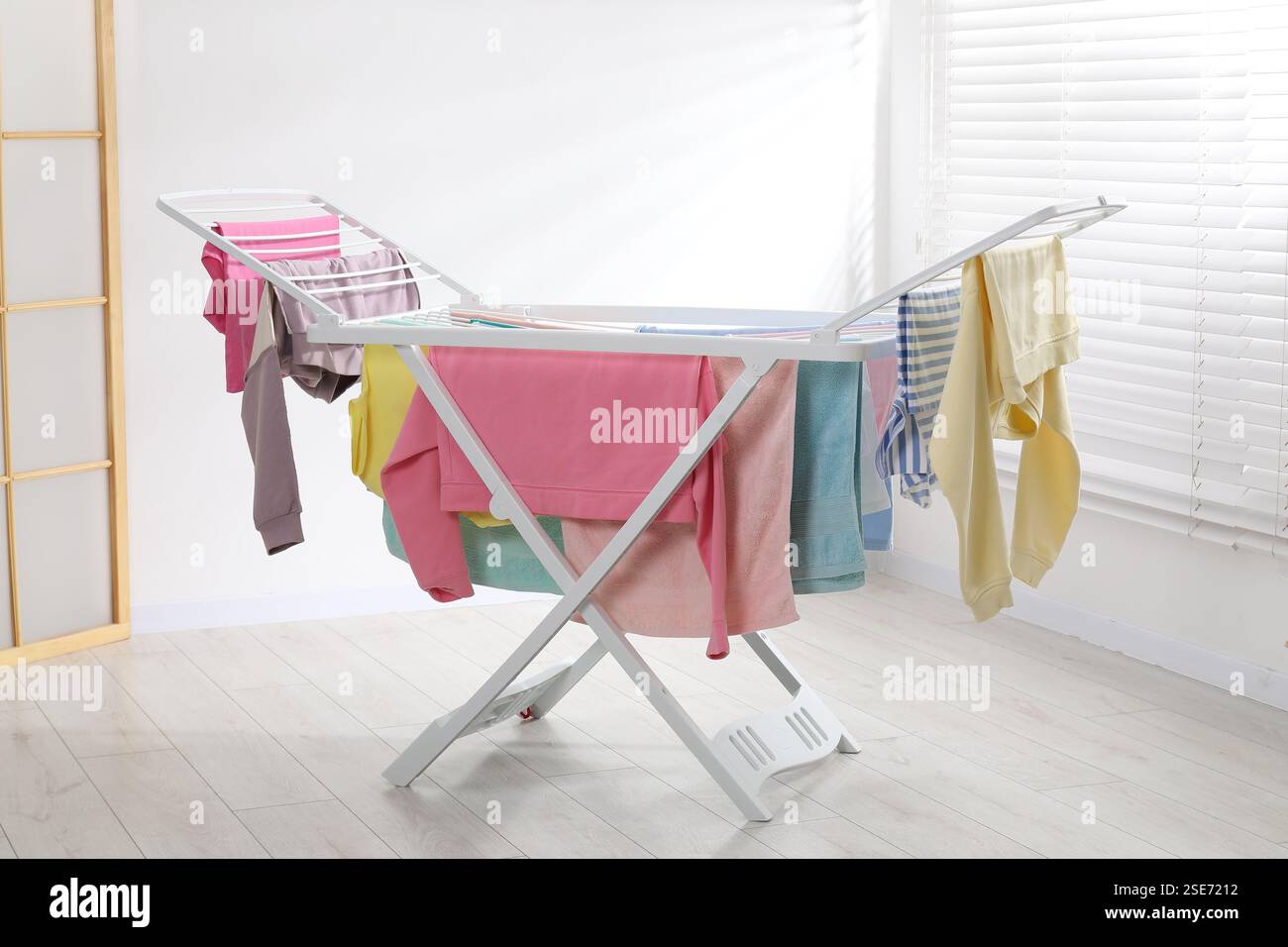 Drying rack with fresh clean laundry at home Stock Photo - Alamy