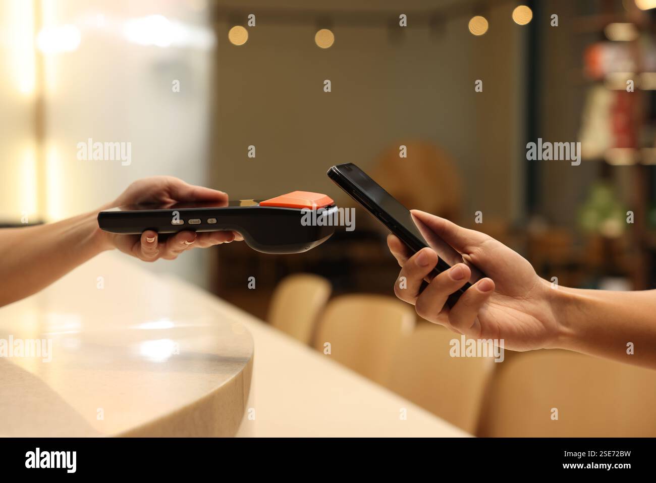 Man paying with smartphone via terminal in cafe, closeup Stock Photo ...