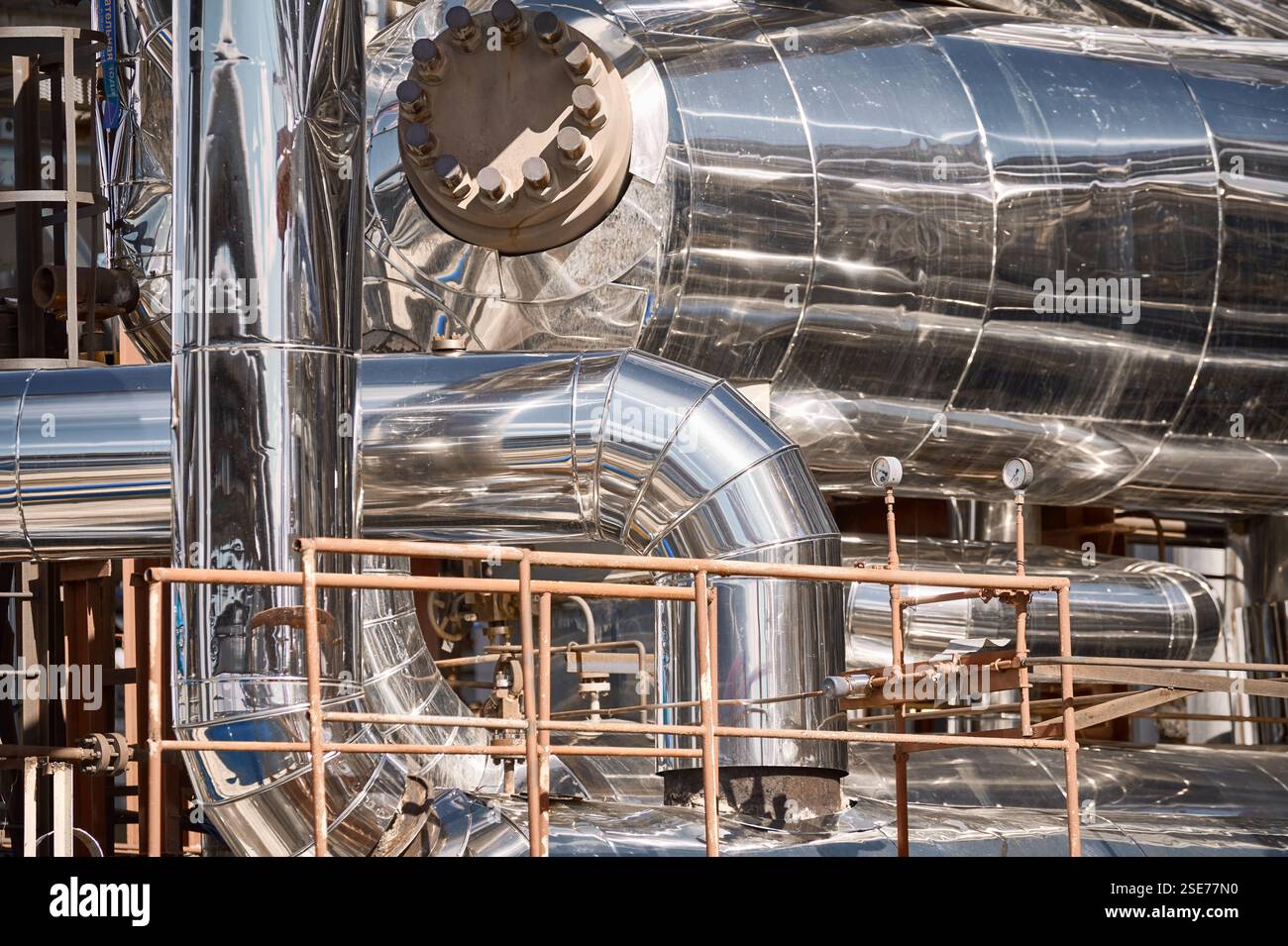 Industrial pipes and machinery at a chemical plant showcasing metalwork ...